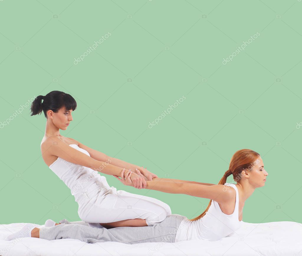 Woman getting thai stretching massage — Stock Photo © shmeljov #136039980