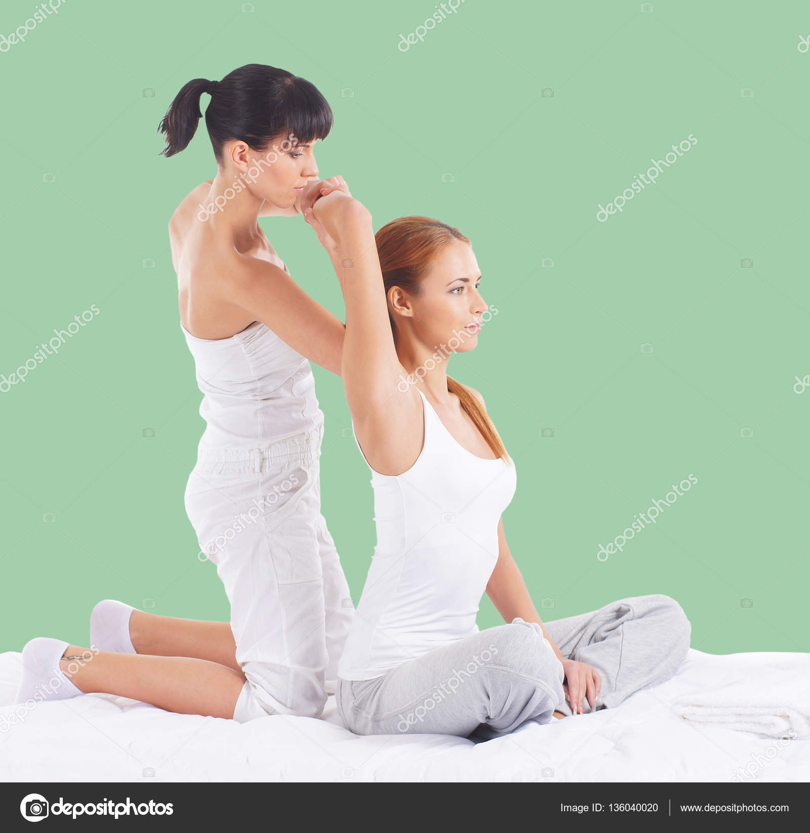 Woman getting thai stretching massage Stock Photo by ©shmeljov 136040020
