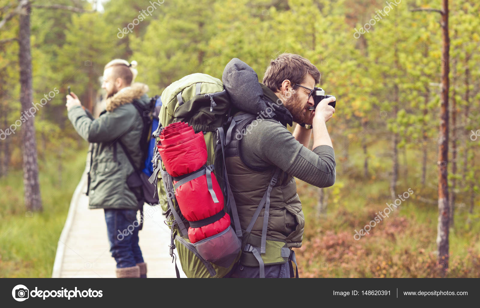 Two men hiking in forest Stock Photo by ©shmeljov 148620391