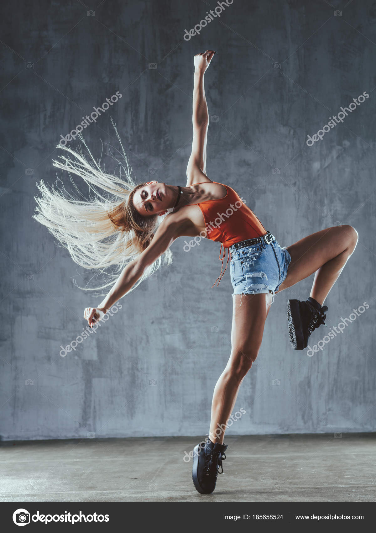 Young beautiful female dancer is posing in the studio — Stock Photo ...