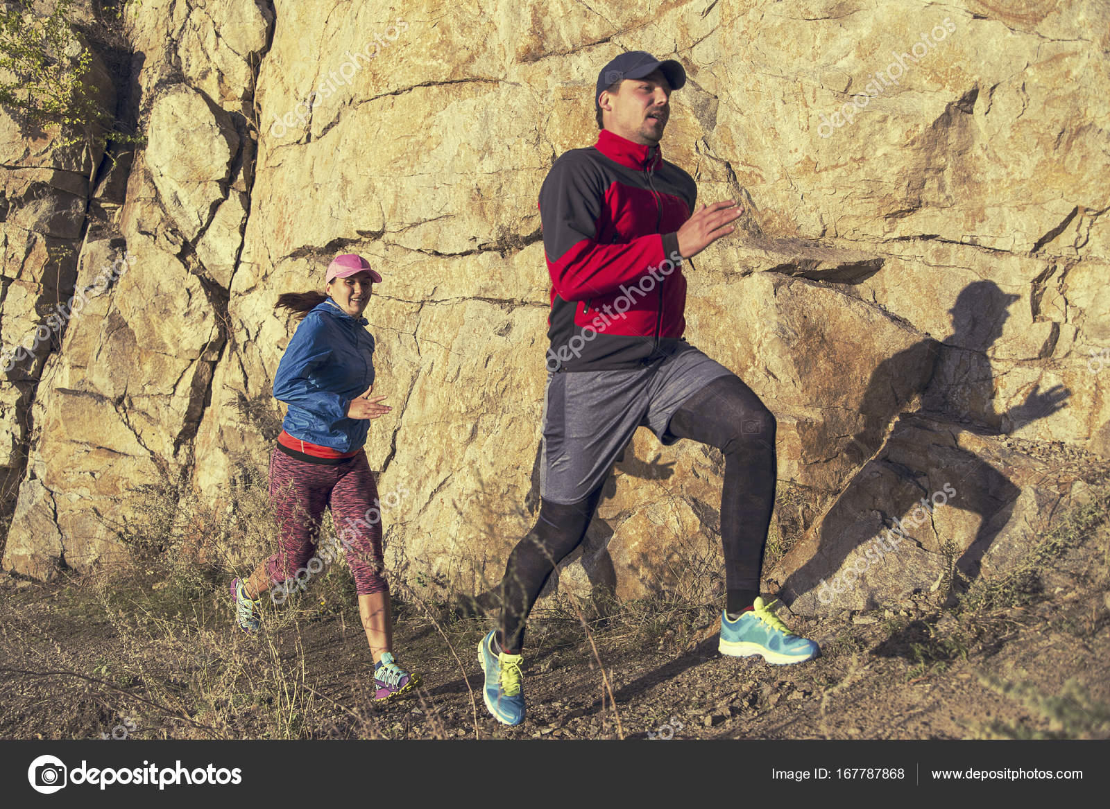 Trail running couple runners racing on mountain path in volcanic Stock ...