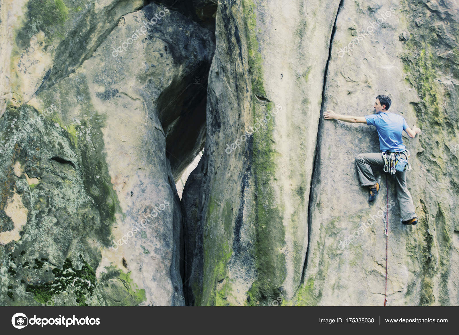 A climber climbs an ascent to a cliff. Stock Photo by ©vetal1983 175338038