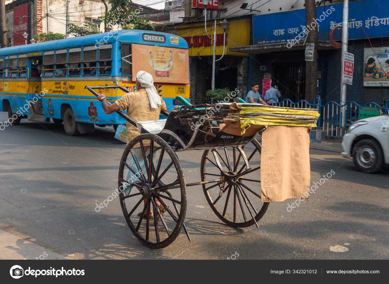 Man rickshaw puller is pulling his hand rickshaw on the street in ...