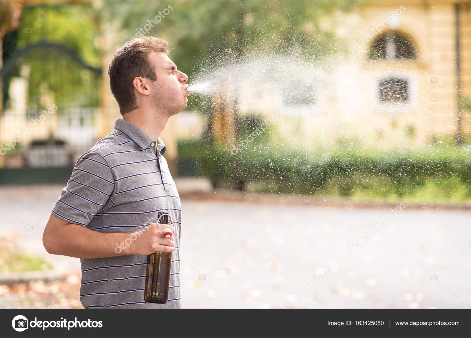 Young man spit out alcohol — Stock Photo © sssss1gmel #163425080