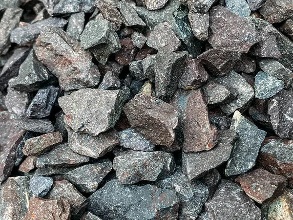 Rough stones, crushed stone, granite gravel close-up. The rough texture ...