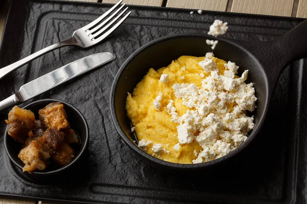 Typical Ukrainian dish polenta - Banosh with cheese and lard. Ukrainian ...