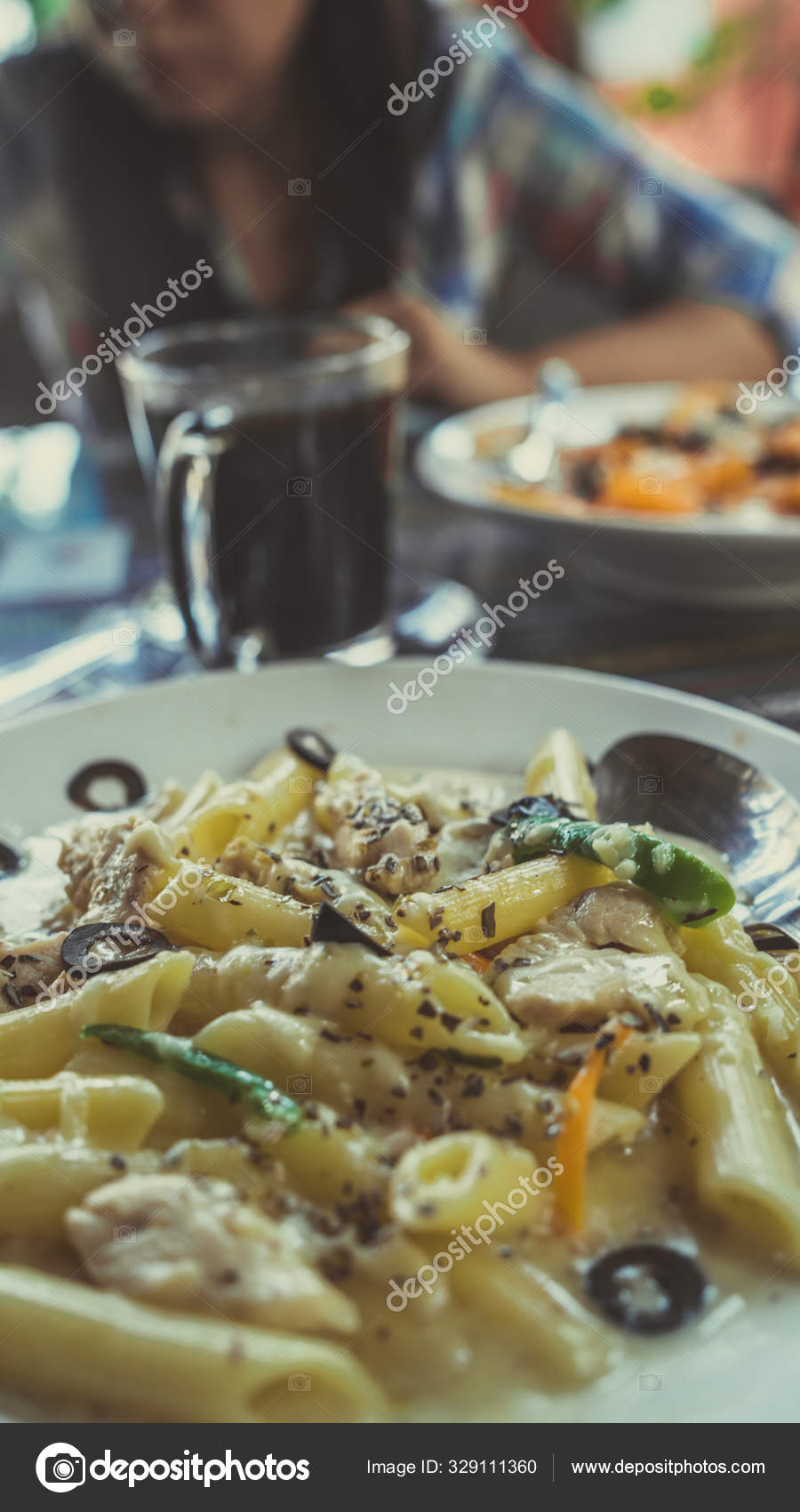 Yummy pasta on cafe table. Closeup plate with portion of tasty pasta ...