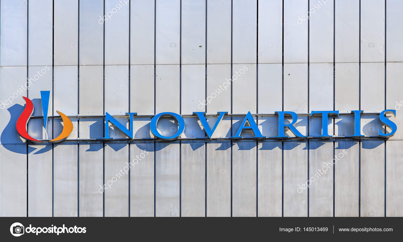 Sign on the wall of a Novartis building in the city of Basel ...