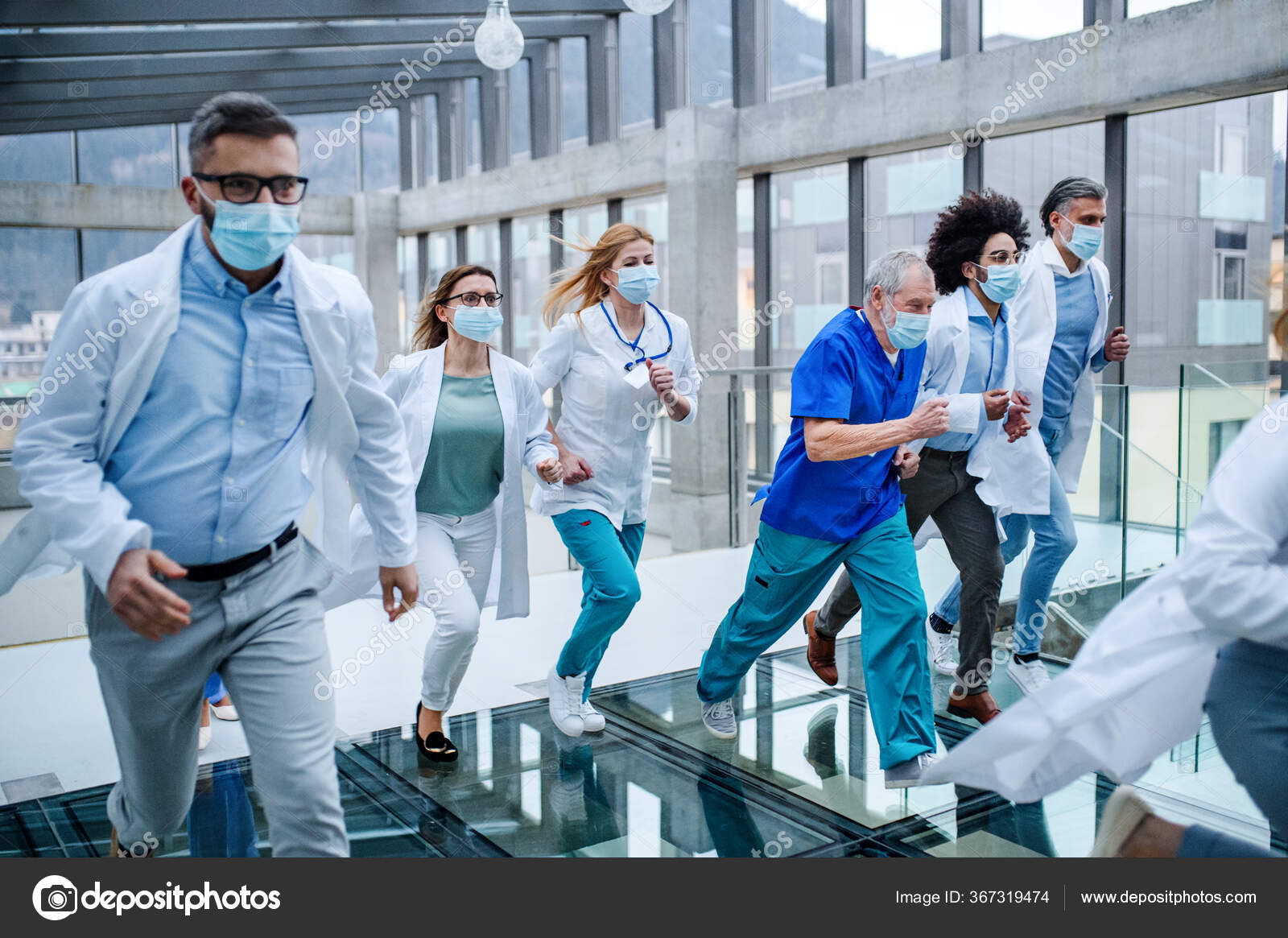 Group of doctors running in corridor of hospital, emergency concept ...