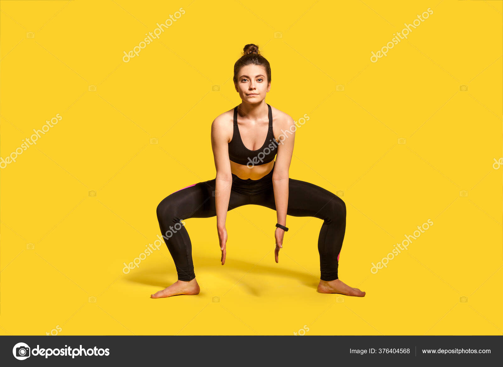 Motivated Athletic Woman Hair Bun Tight Sportswear Doing Frog Squat