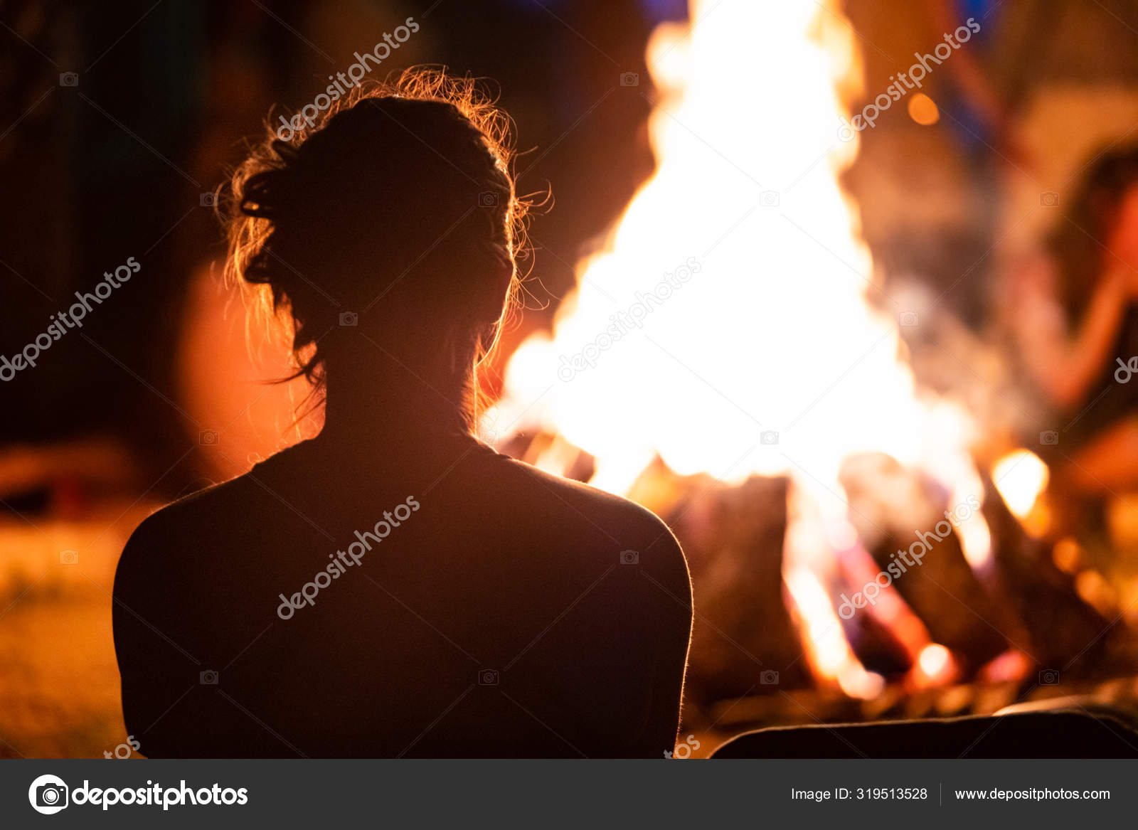 Man sitting in the front of the fire Stock Photo by ©Valmedia 319513528