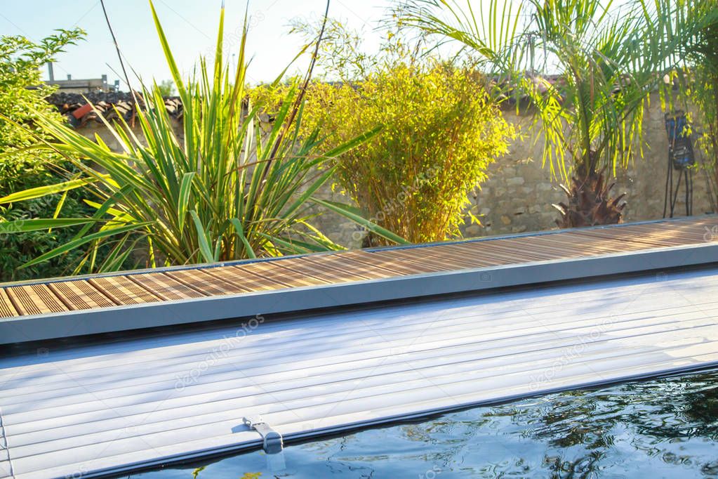 Swimming pool roller-shutter covers Stock Photo by ©Pixinooo 128989560