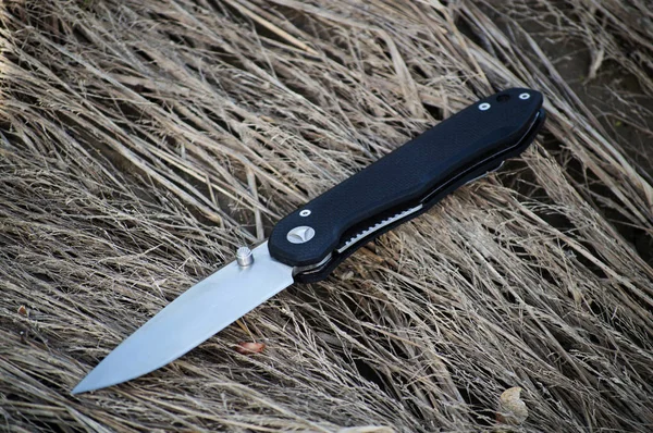 folding travel knife in stainless steel with black handle made o ...