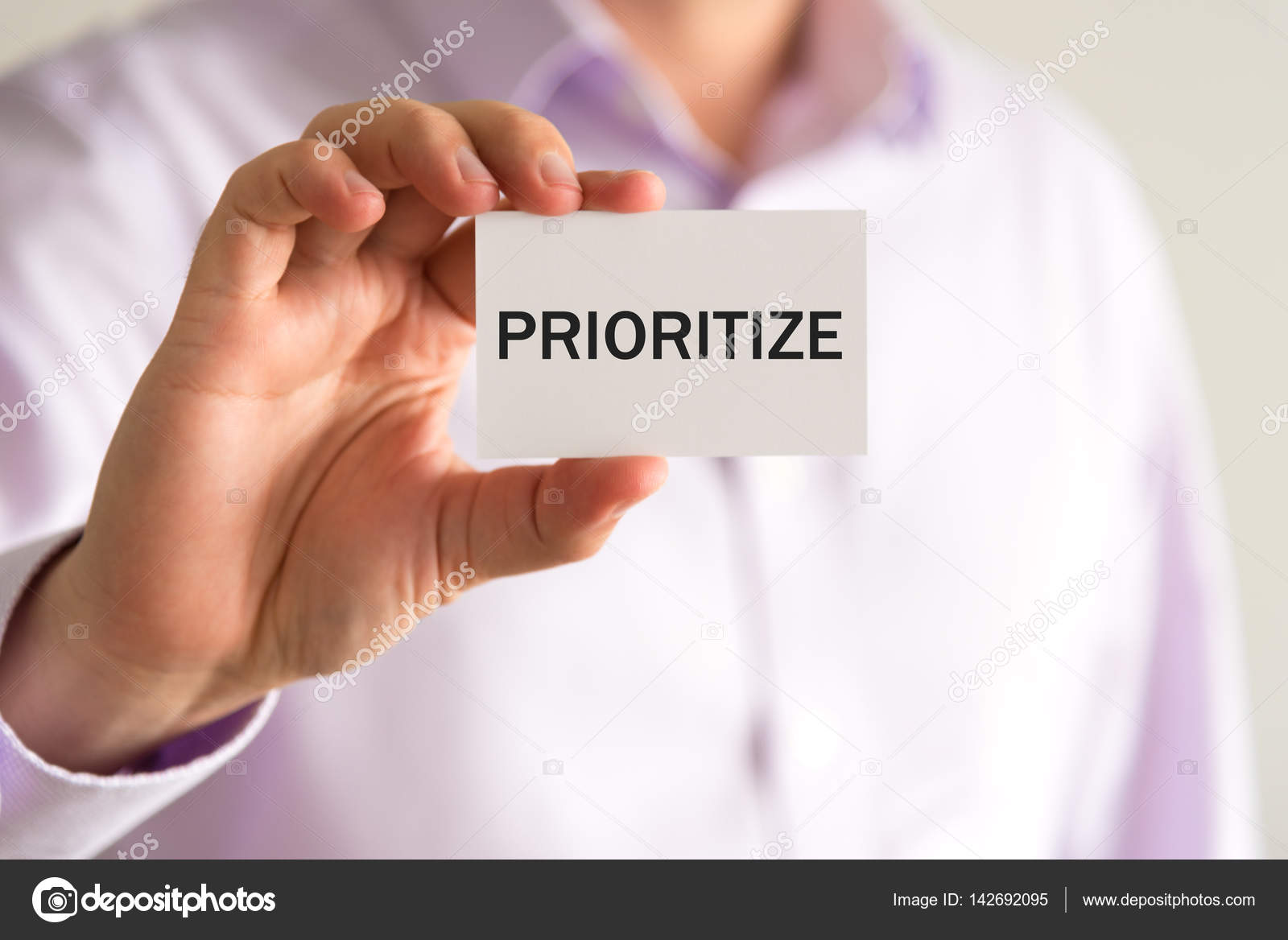 Businessman holding card with text PRIORITIZE — Stock Photo © stanciuc1 ...