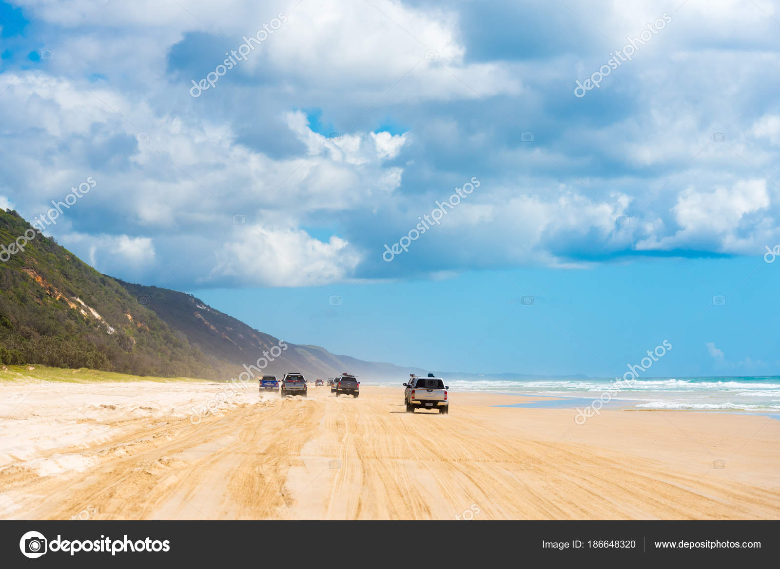 4wd vehicles at Rainbow Beach with coloured sand dunes, QLD, Australia ...