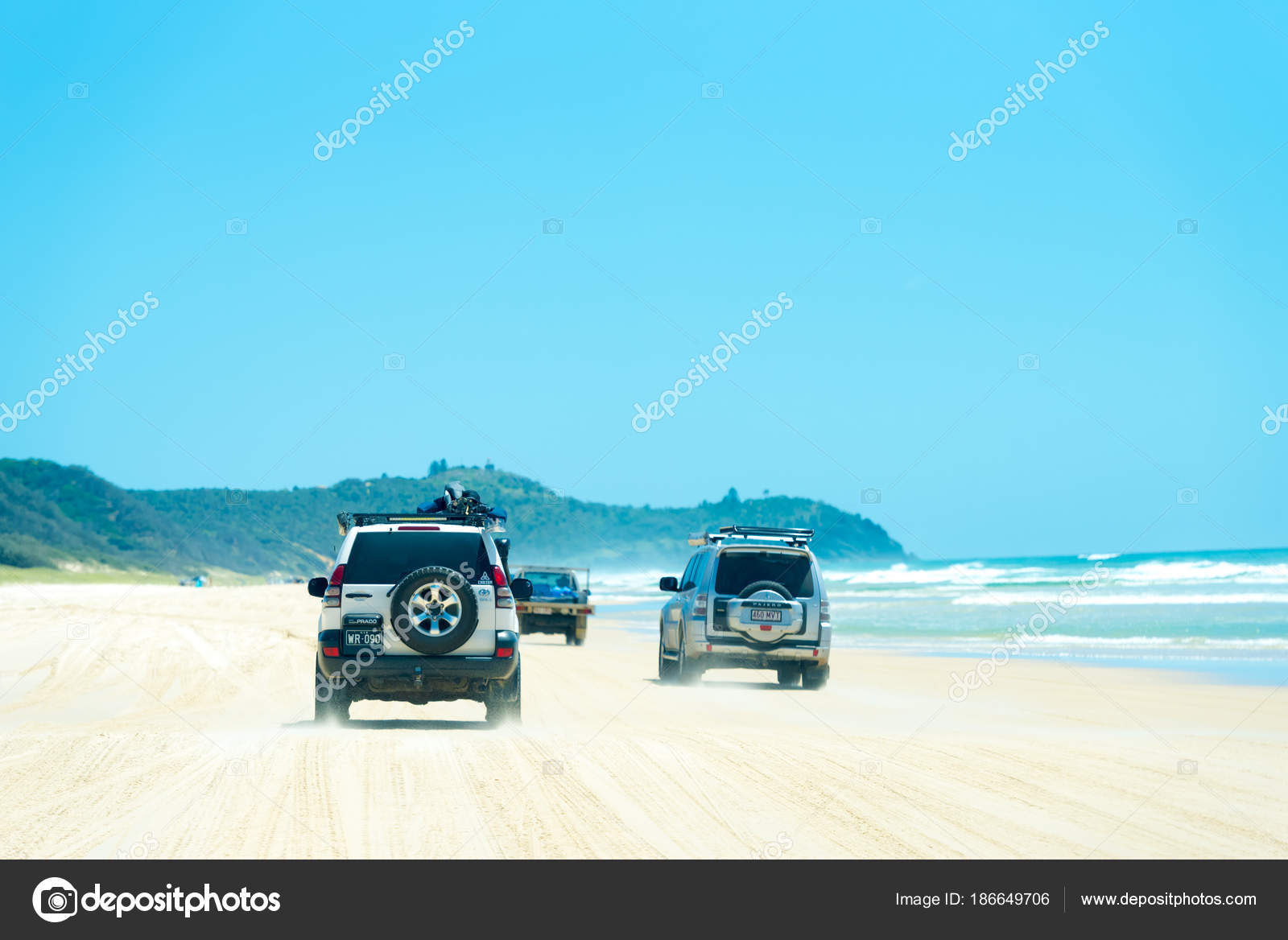 4wd vehicles at Rainbow Beach with coloured sand dunes, QLD, Australia ...
