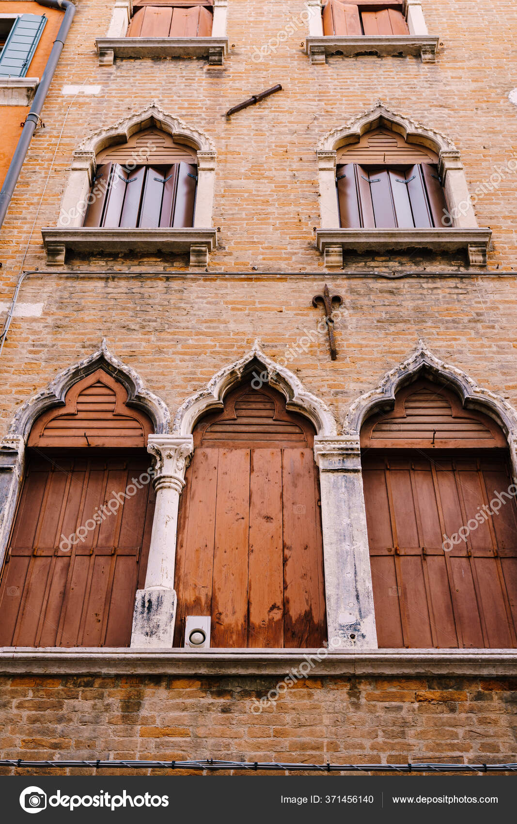 Windows of Venice are a building of several floors, made of red brick ...