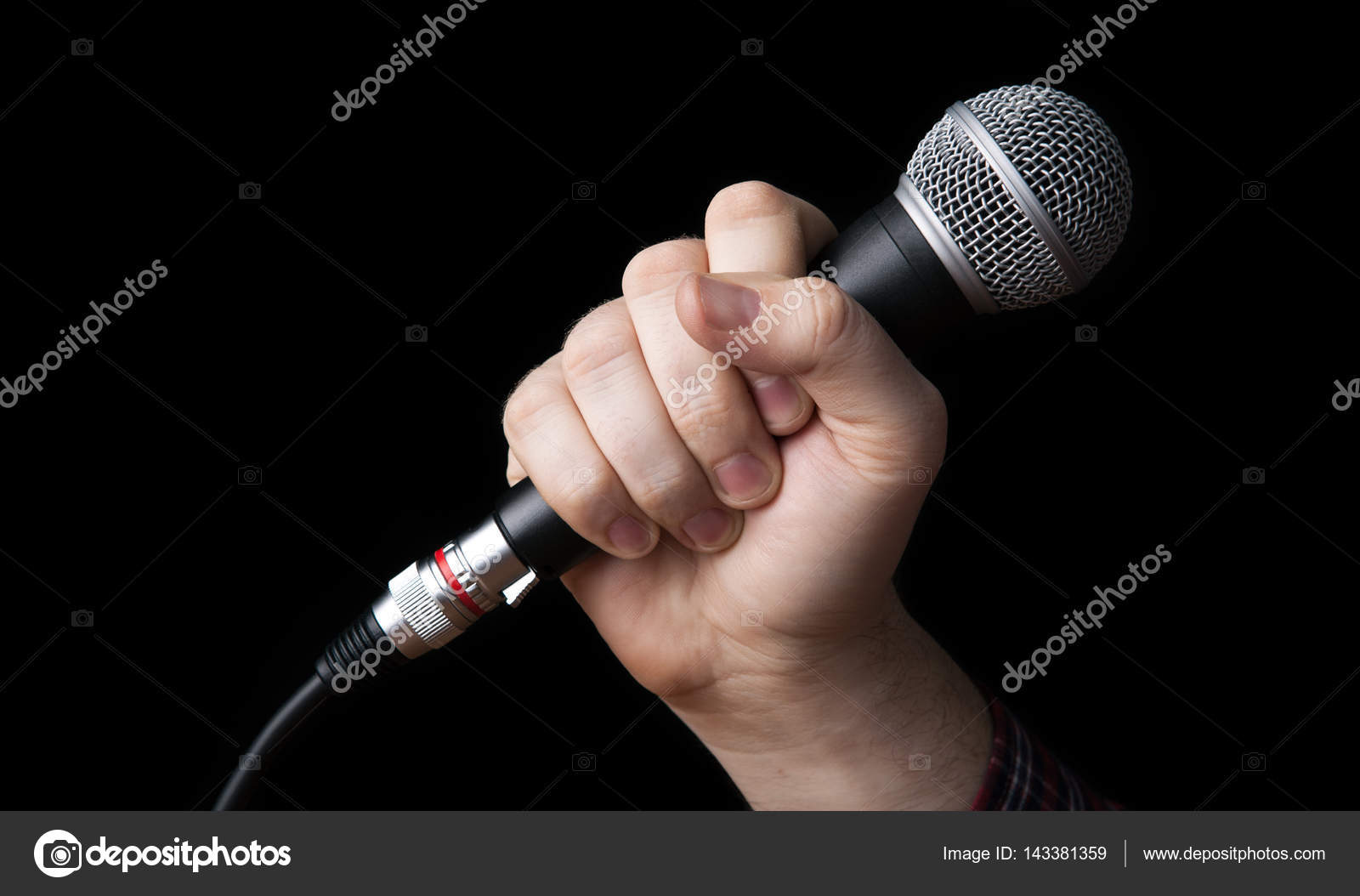 Man's hand holding a microphone Stock Photo by ©mizar_219842 143381359