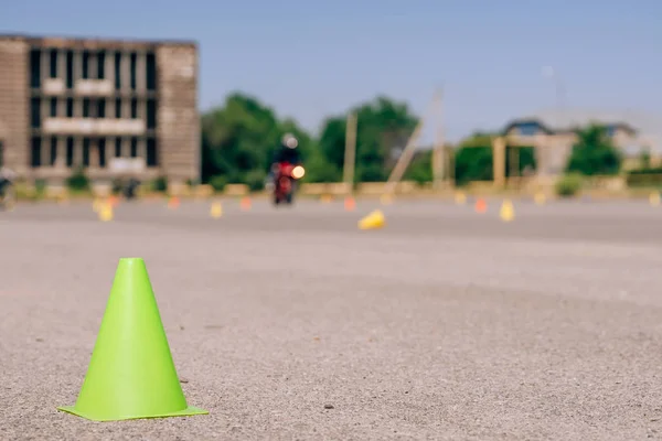 Green cone close-up on the site for bikers. Traffic cones on the ...