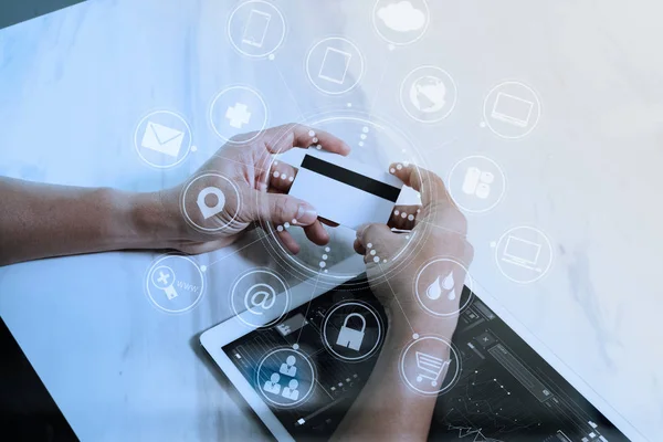 hand using credit cardr with digital tablet computer in modern o ...