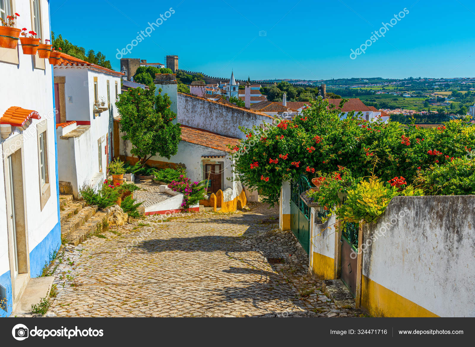 A narrow street inside of the obidos castle in Portugal — Stock Photo ...