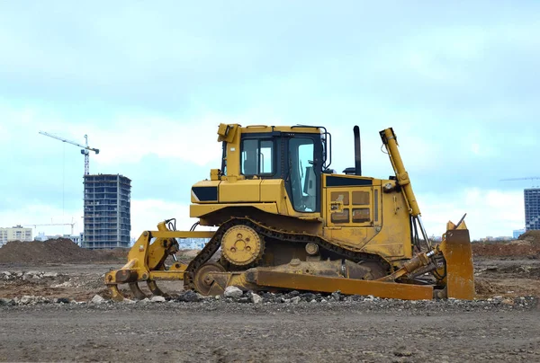 Earth moving by a bulldozer in the construction of a road in Indonesia ...