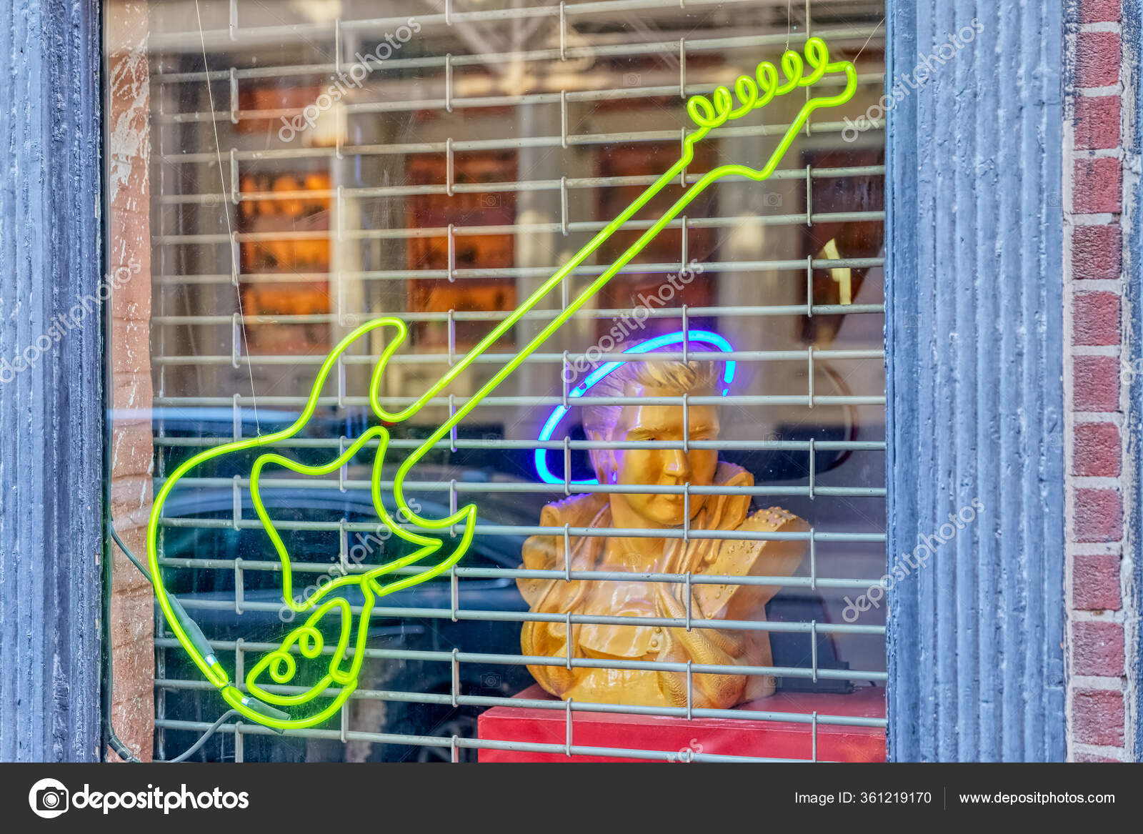 Neon guitar and bust of Elvis Presley in a window in downtown Manhattan ...