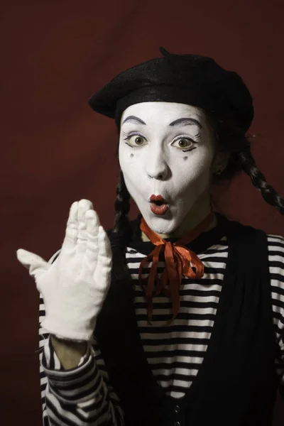 Beautiful girl mime smiles and makes a gesture of a beating heart with ...