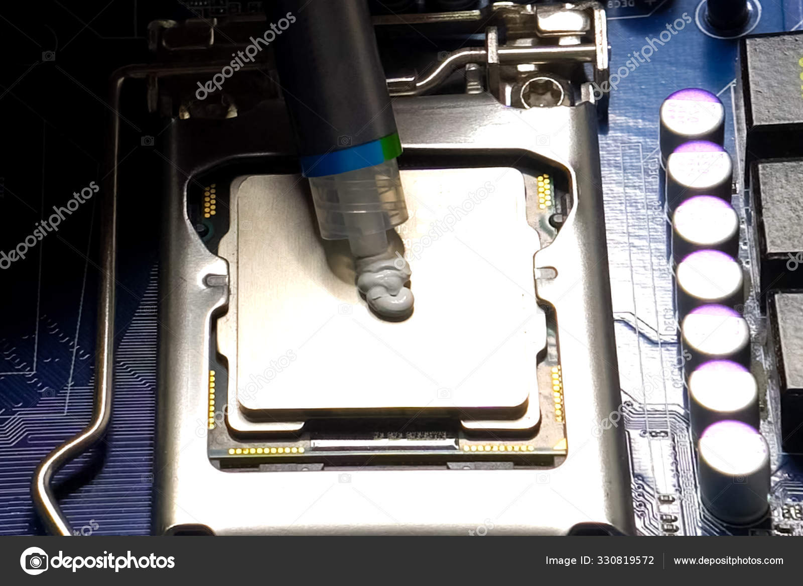 Drawing thermal paste on computer processor. Installing a coolin ...