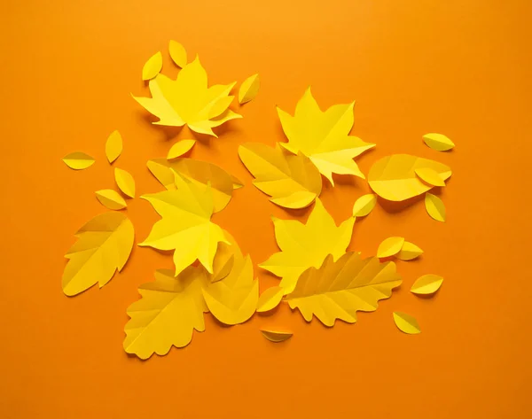 Autumn leaves made from paper on an orange background. September ...