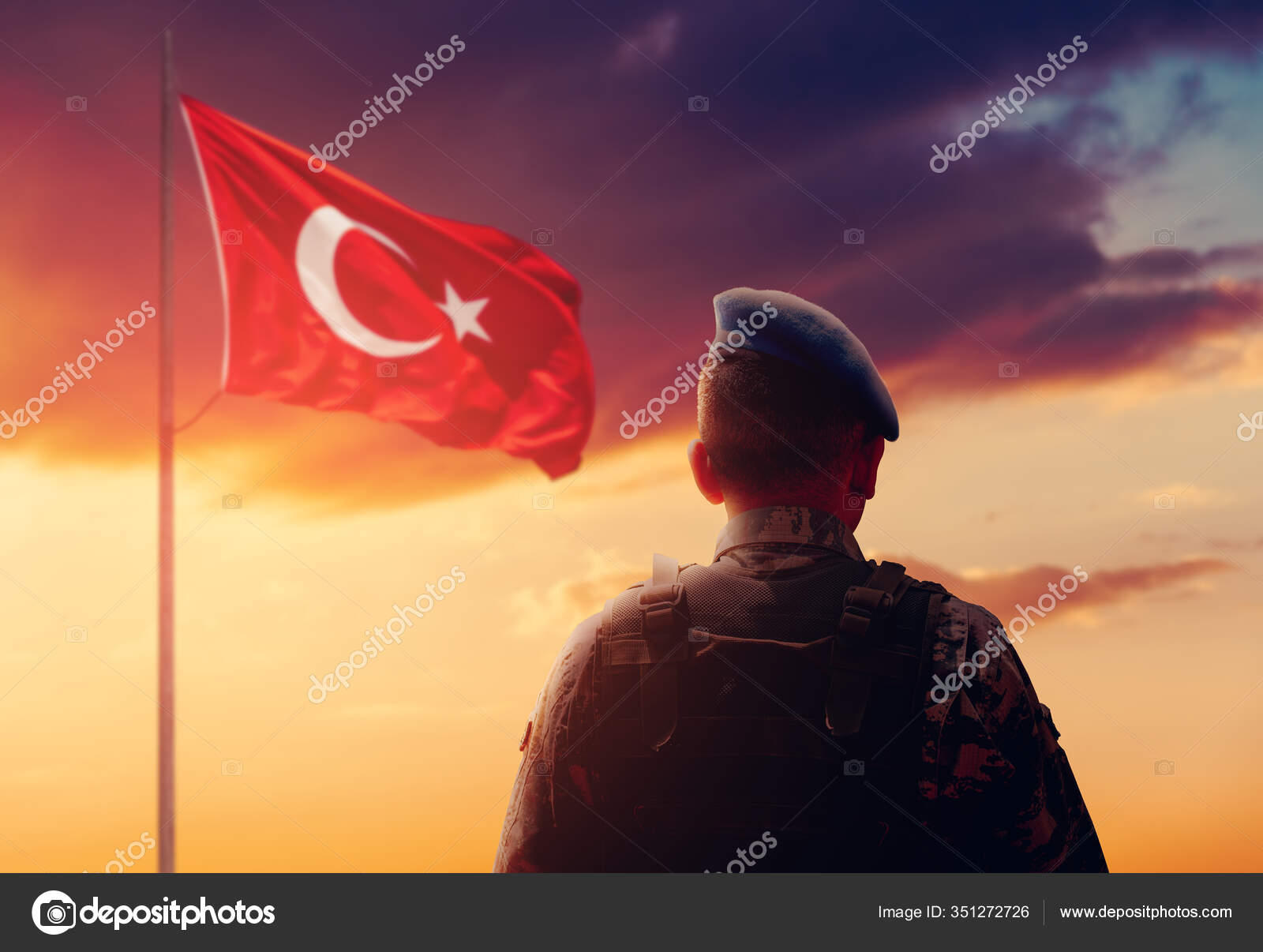 Turkish Soldier is stand and salute front of Turkish Flag on his watch ...