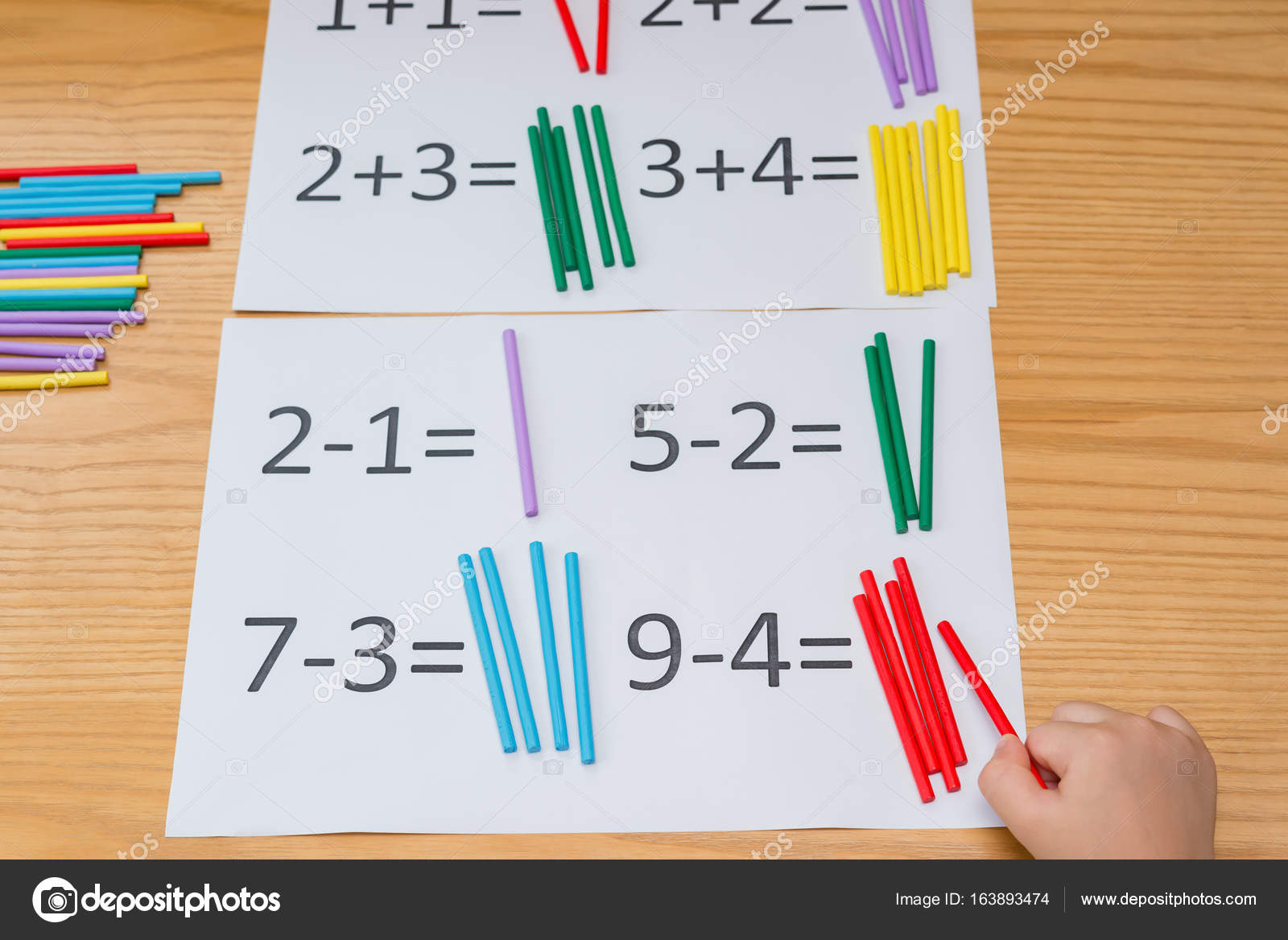 Kid learning simple subtraction and addition by counting numbers of ...