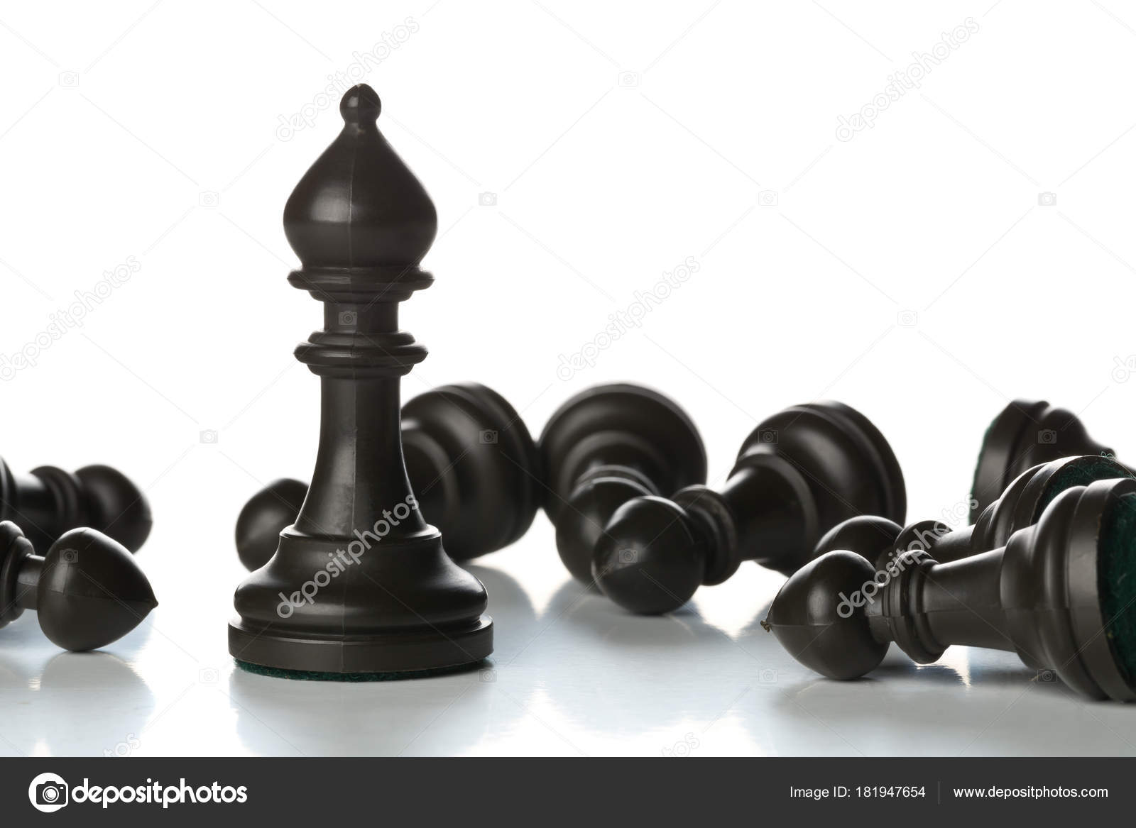 Runner chess figure standing in between fallen over pawn chess f ...