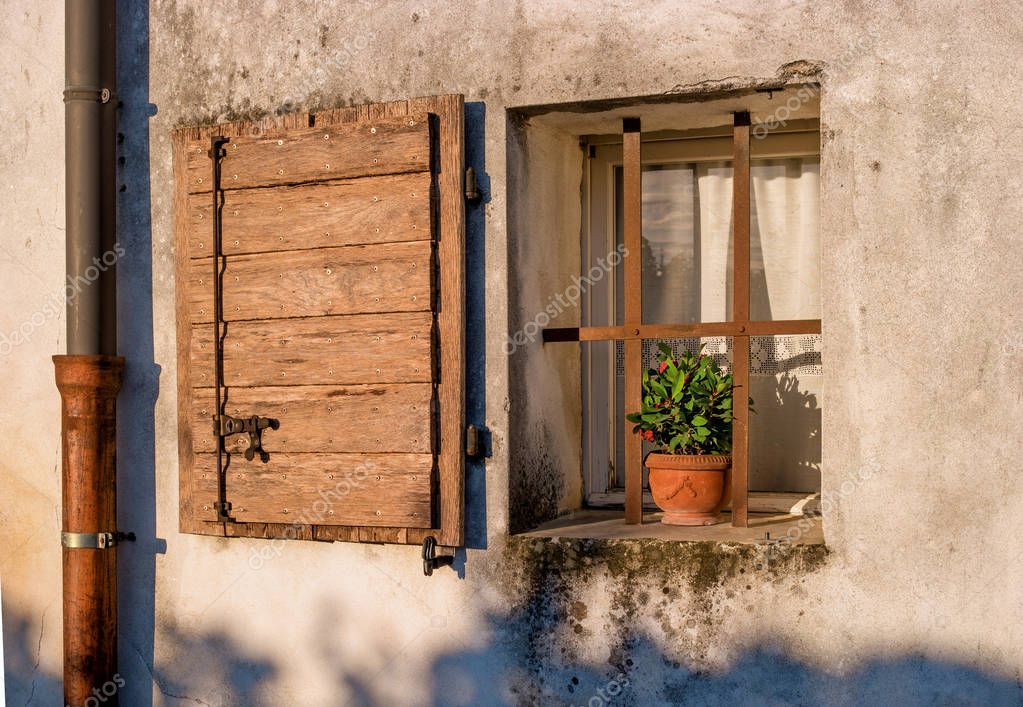 Old house window with open shutters and flower. Italian Village ...