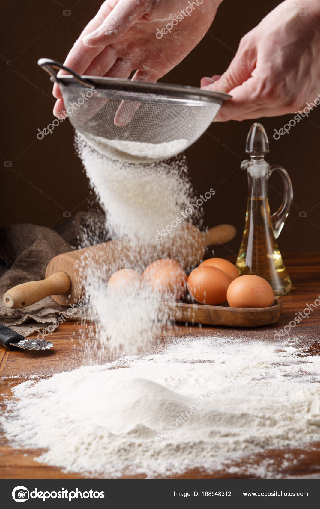 Chef sifting flour through sieve for baking Stock Photo by ...