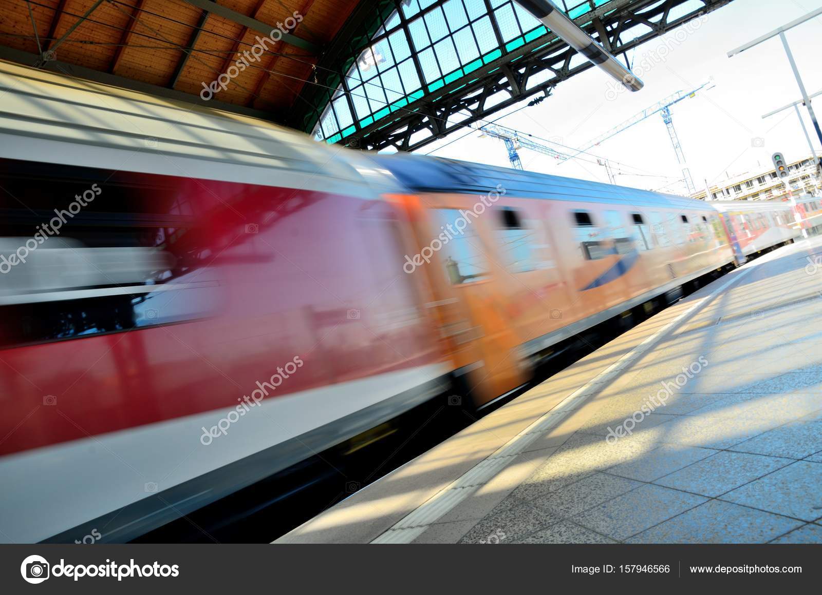 Train passing railway station Stock Photo by ©bartekchiny 157946566