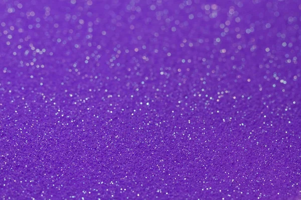 Abstract violet glitter background with shining light and soft bokeh ...