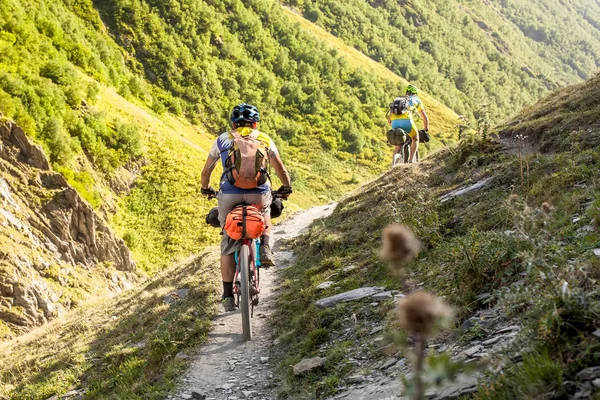 Family riding bikes in the mountains — Stock Photo © Goodluz #13936885