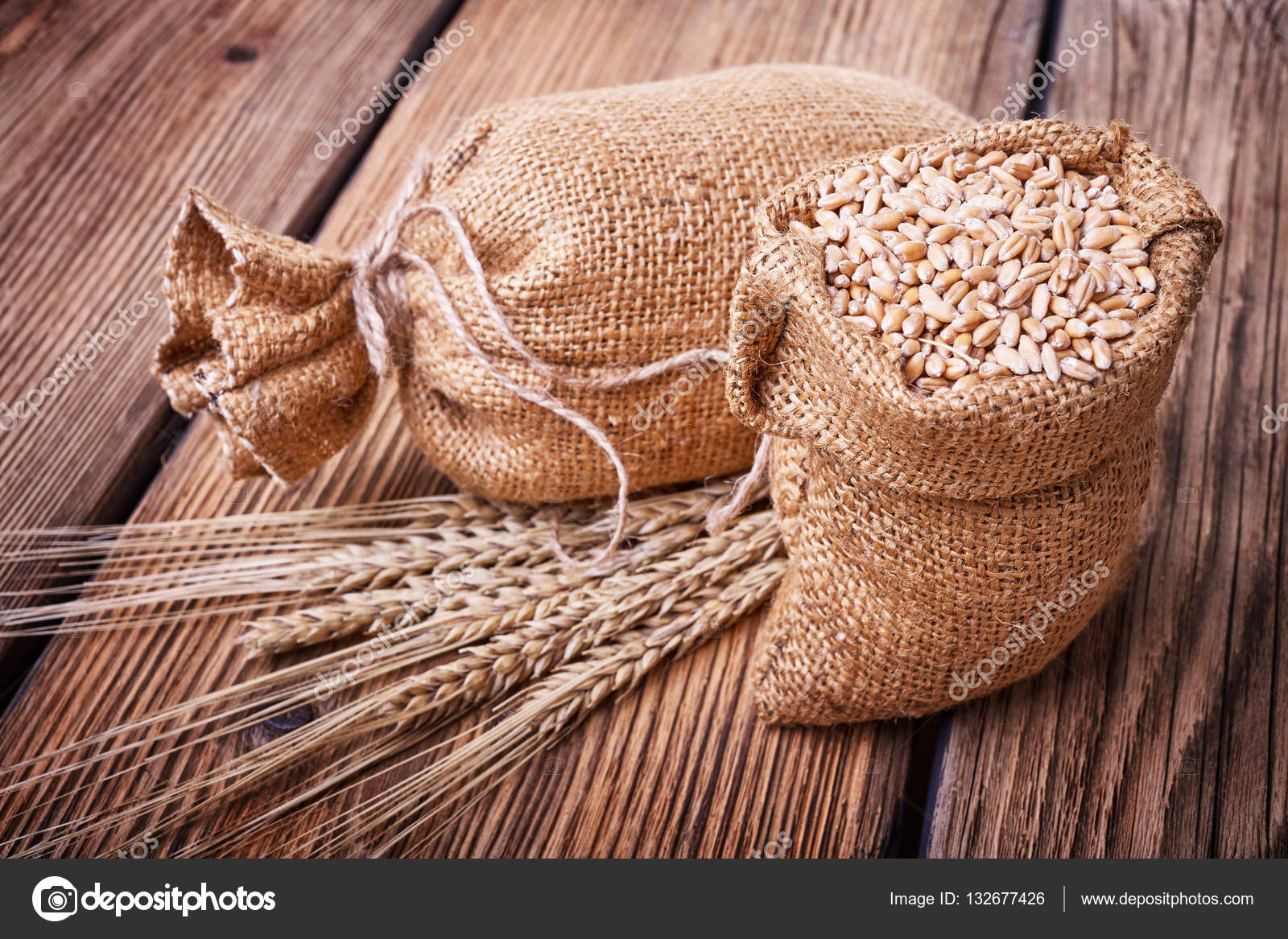 Sacks of grain and wheat ears Stock Photo by ©Veremeev 132677426
