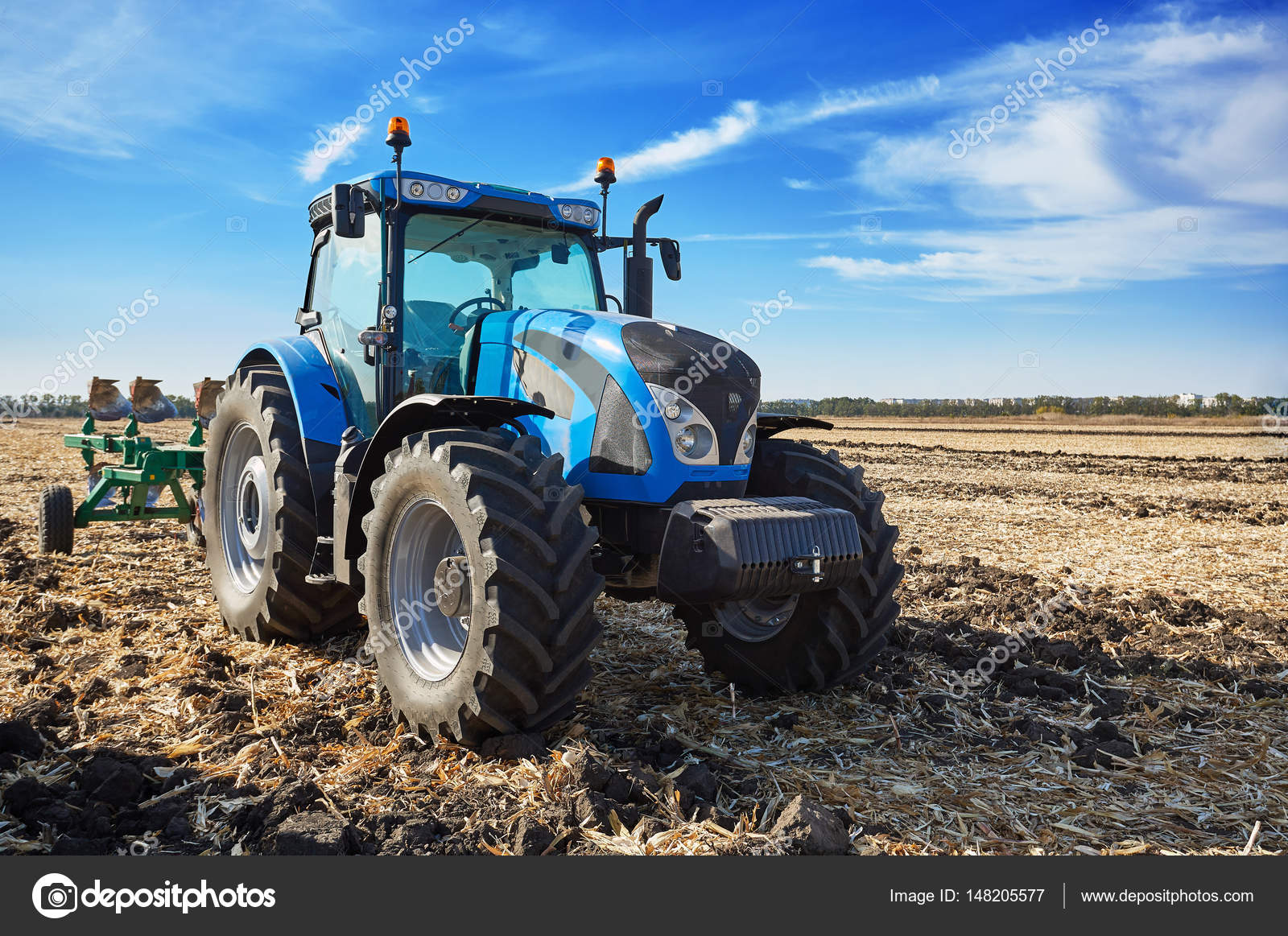 Tractor working in field Stock Photo by ©Veremeev 148205577
