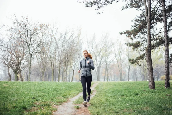 Young woman running in park - Stock Image - Everypixel