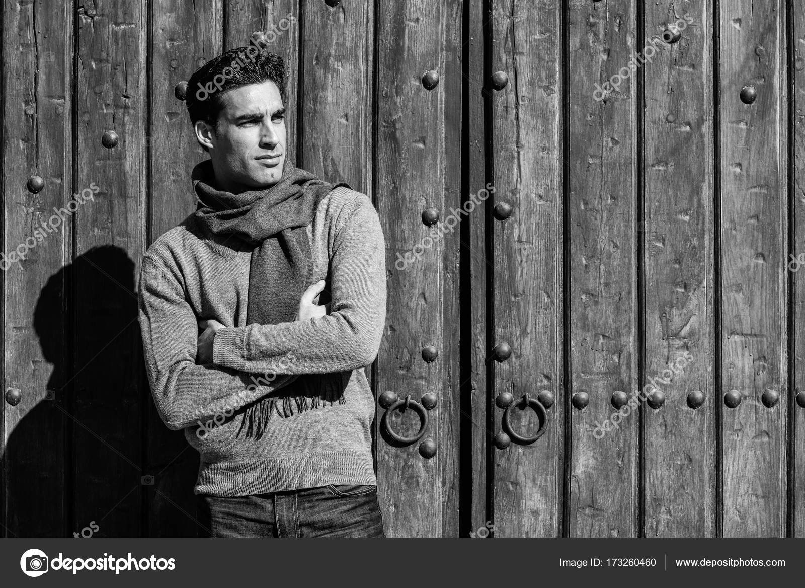 Handsome man wearing winter clothes in wooden background. Stock Photo ...