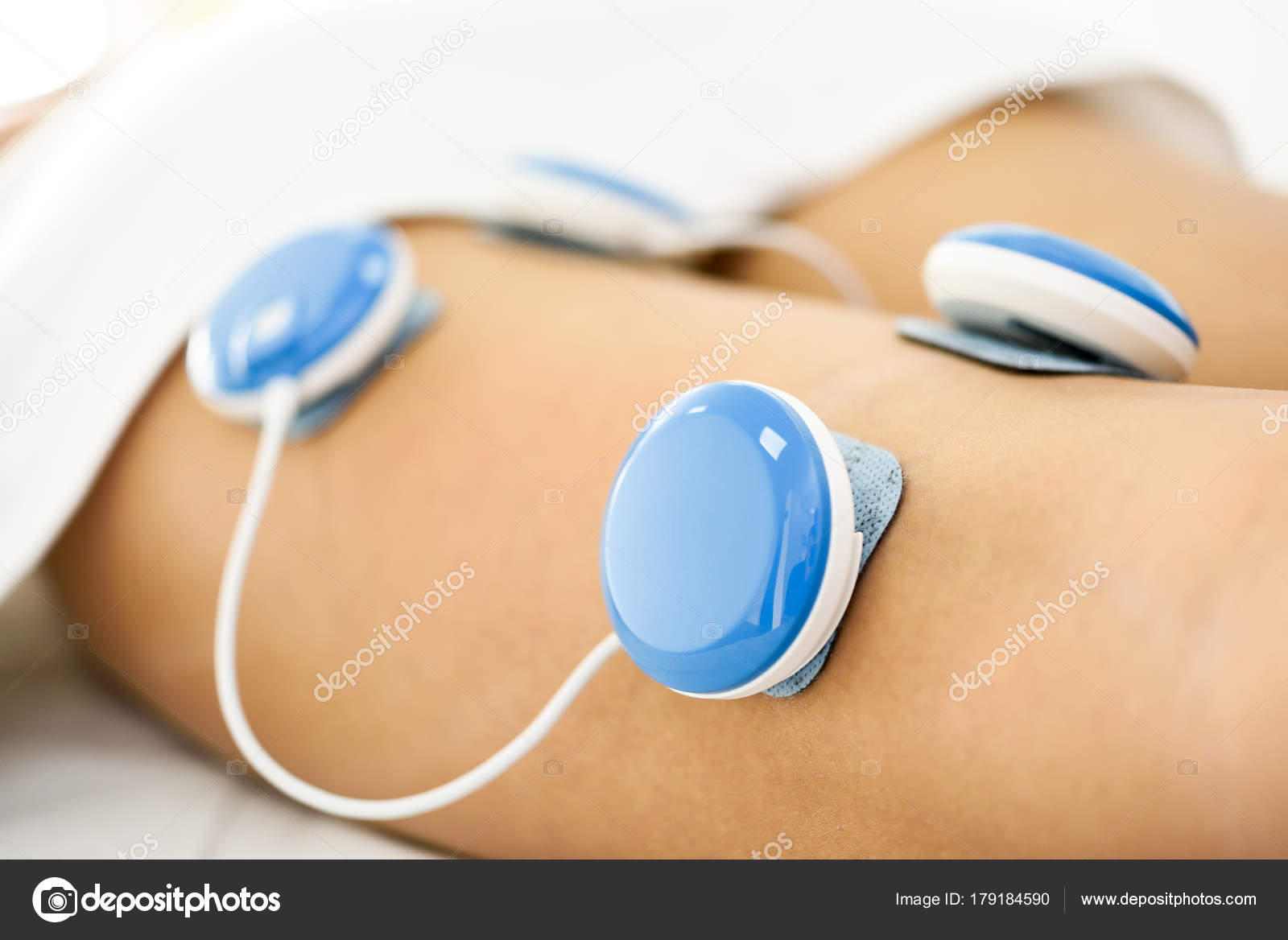 Electro stimulation in physical therapy to a young woman leg. Stock ...