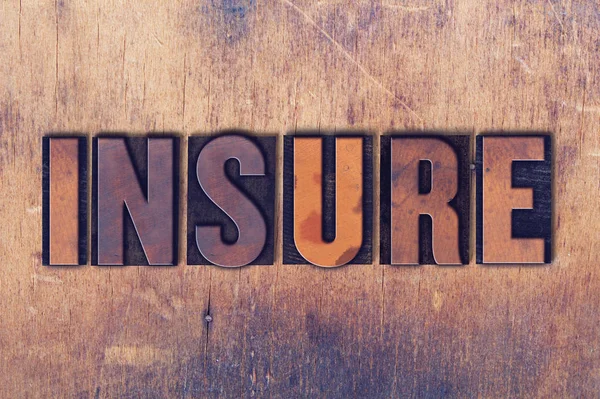 Insure Theme Letterpress Word on Wood Background - Stock Image - Everypixel