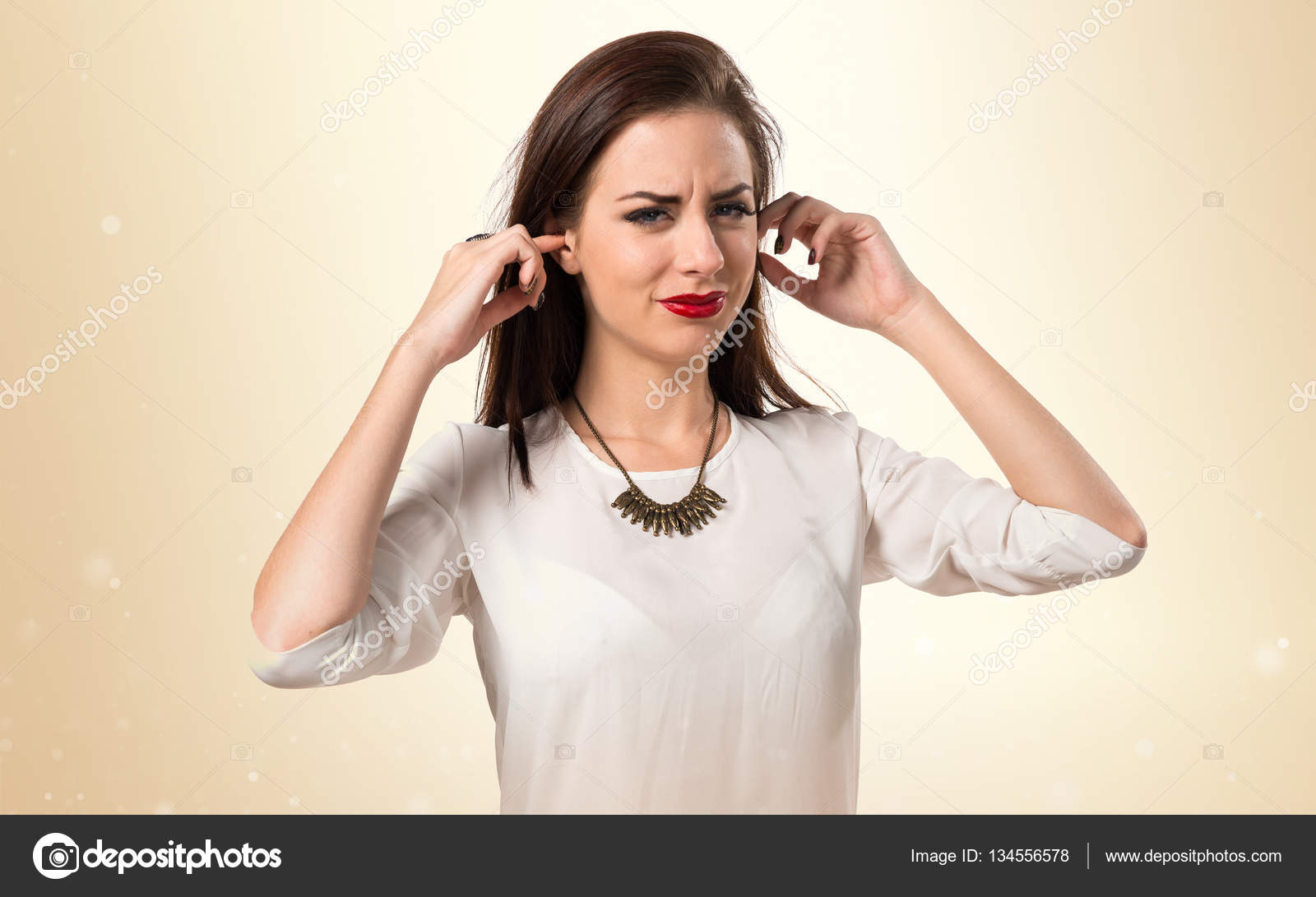 Pretty young girl covering her ears Stock Photo by ©luismolinero 134556578