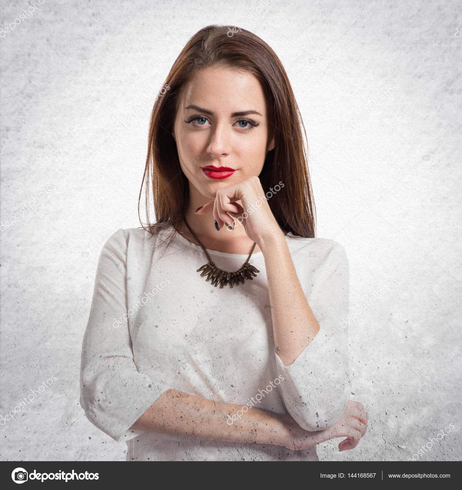 Pretty young girl thinking on textured grey background Stock Photo by ...
