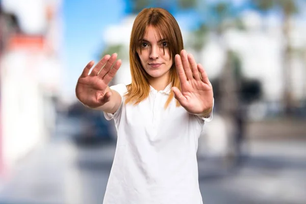 Beautiful young girl making stop sign on unfocused background — Stock ...