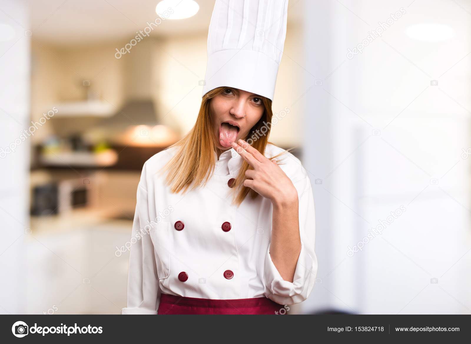 Beautiful chef woman making vomiting gesture in the kitchen — Stock ...