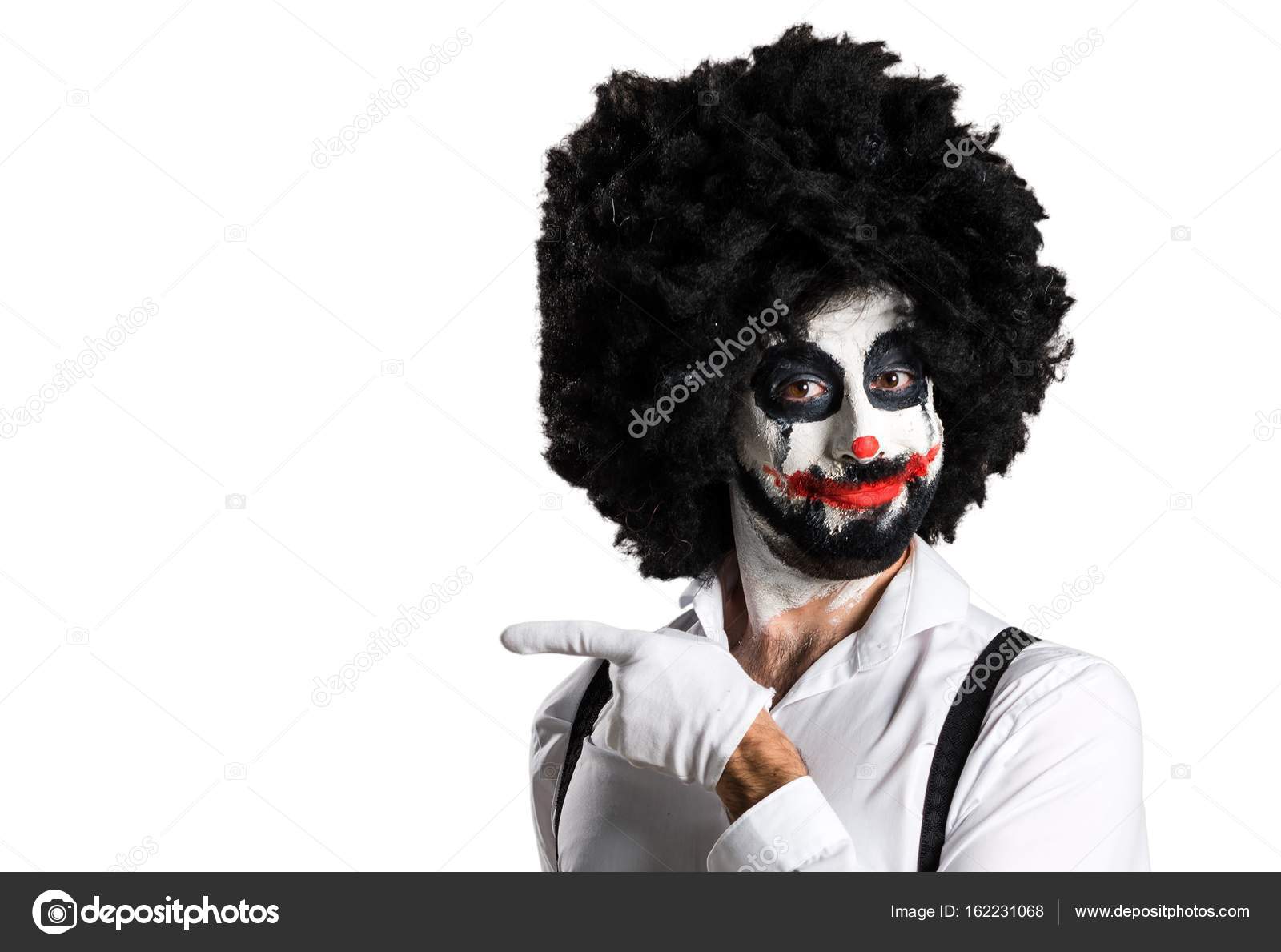 Killer clown pointing to the lateral — Stock Photo © luismolinero ...