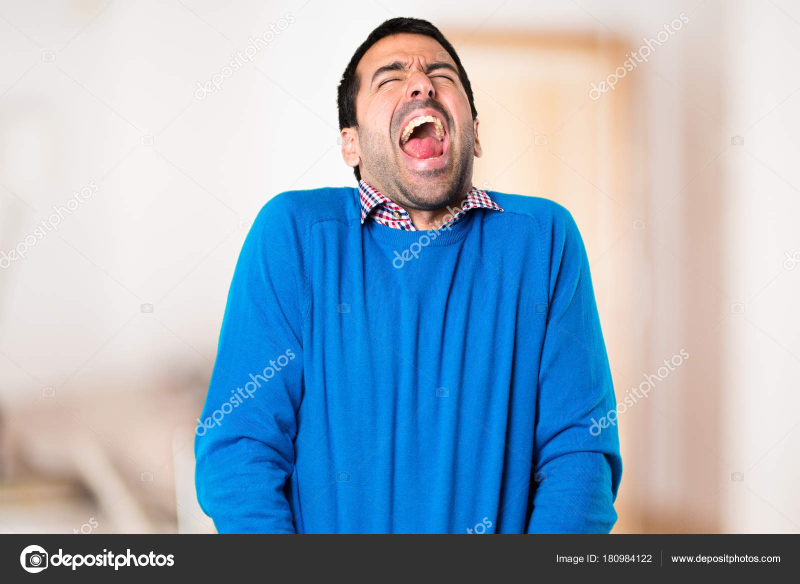 Handsome young man shouting on unfocused background — Stock Photo ...